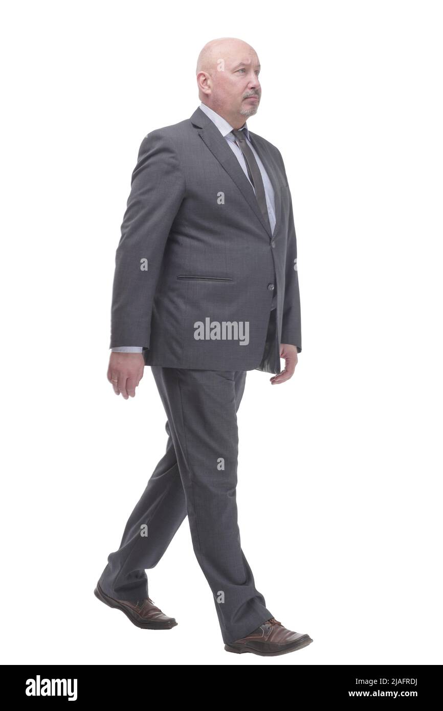 Mature business man striding forward .isolated on a white background ...