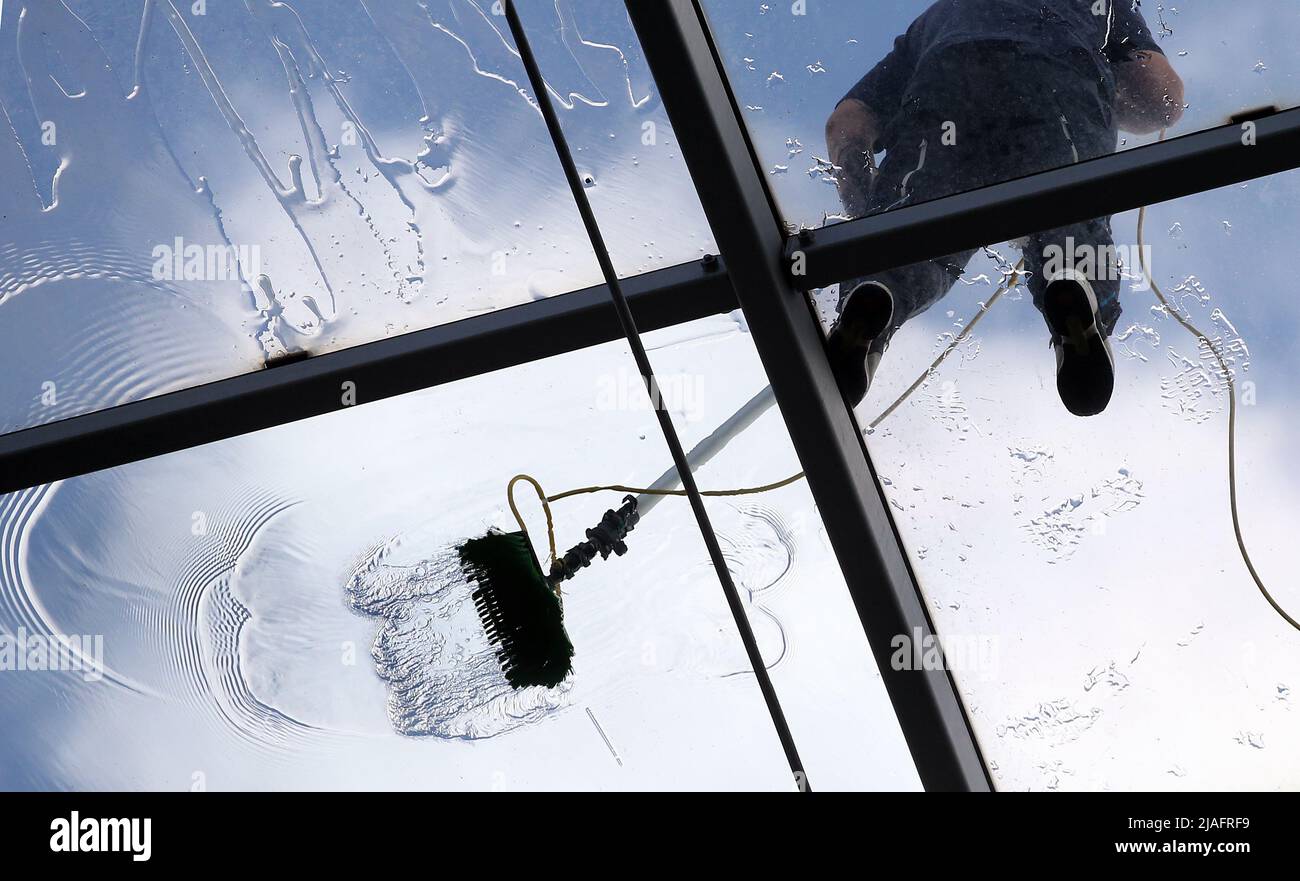 Berlin, Germany. 30th May, 2022. Roped up in lofty heights, a man ...