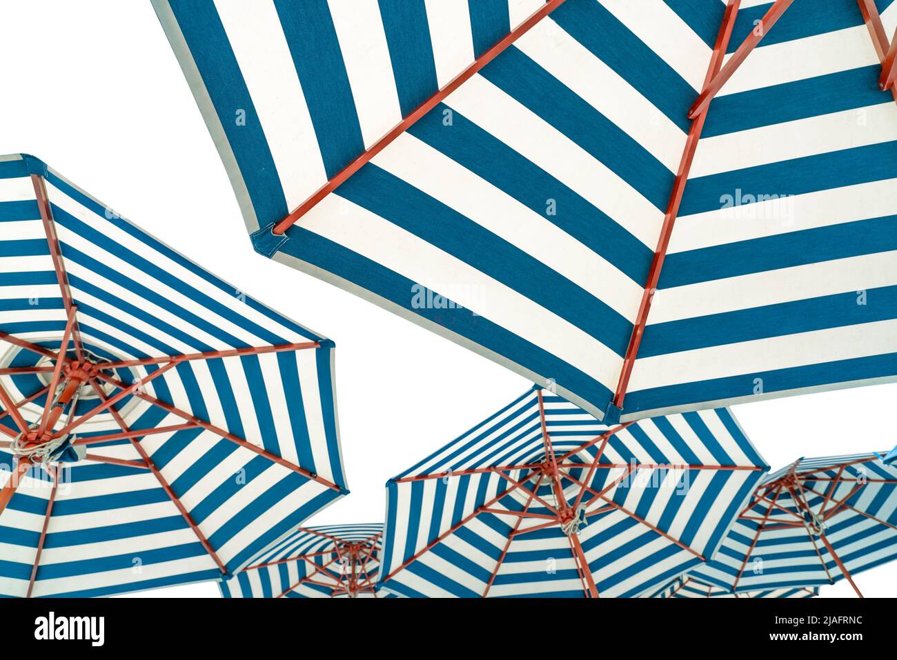 Beach umbrellas isolated on white background. Blue and white striped ...