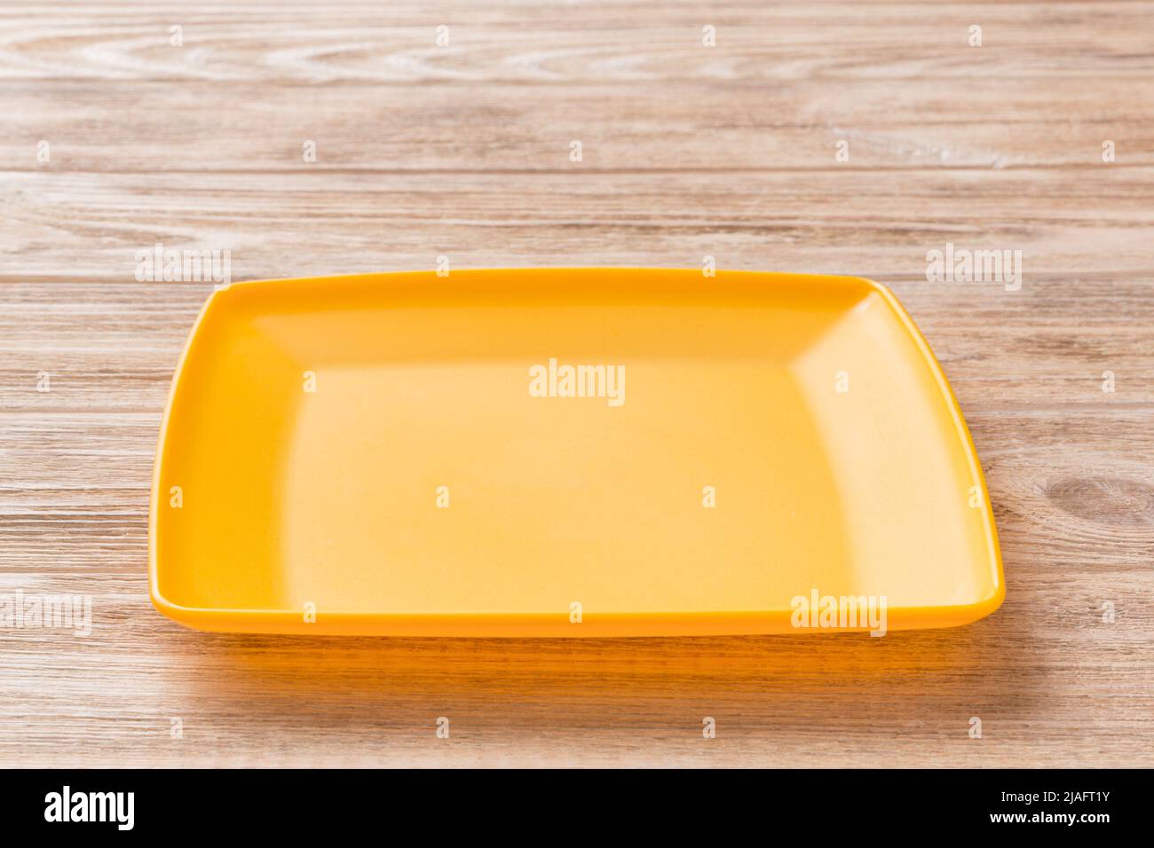 Perspective view of empty square plate on wooden background. Empty ...