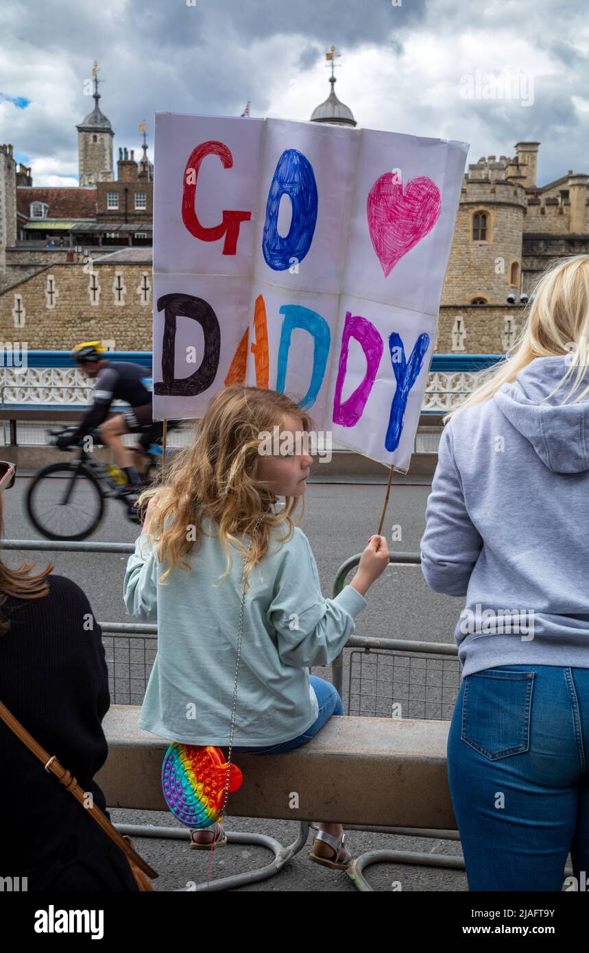 A young girl holds a sign saying "Go Daddy" as she waits for her father ...