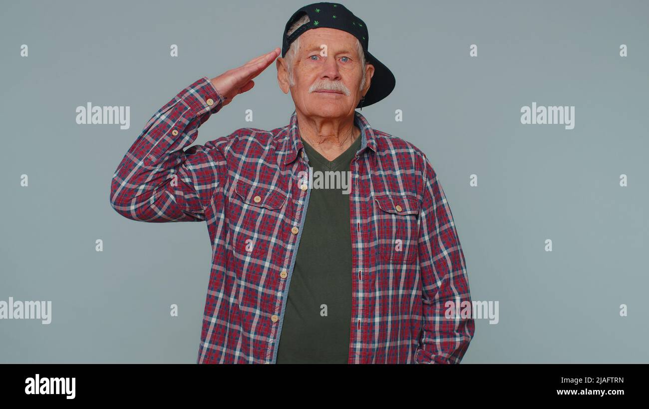 Subordinate senior man giving salute listening to order as if soldier ...