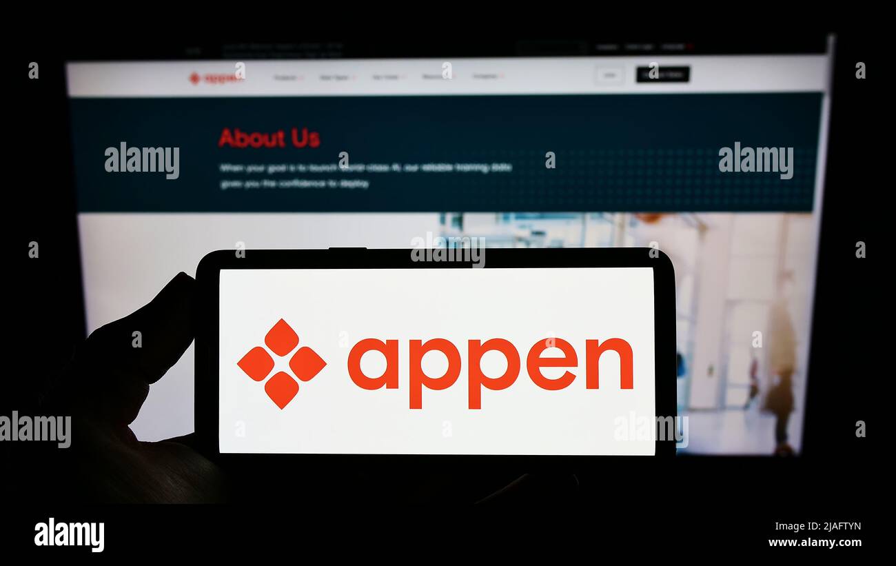 Person holding mobile phone with logo of Australian data company Appen ...