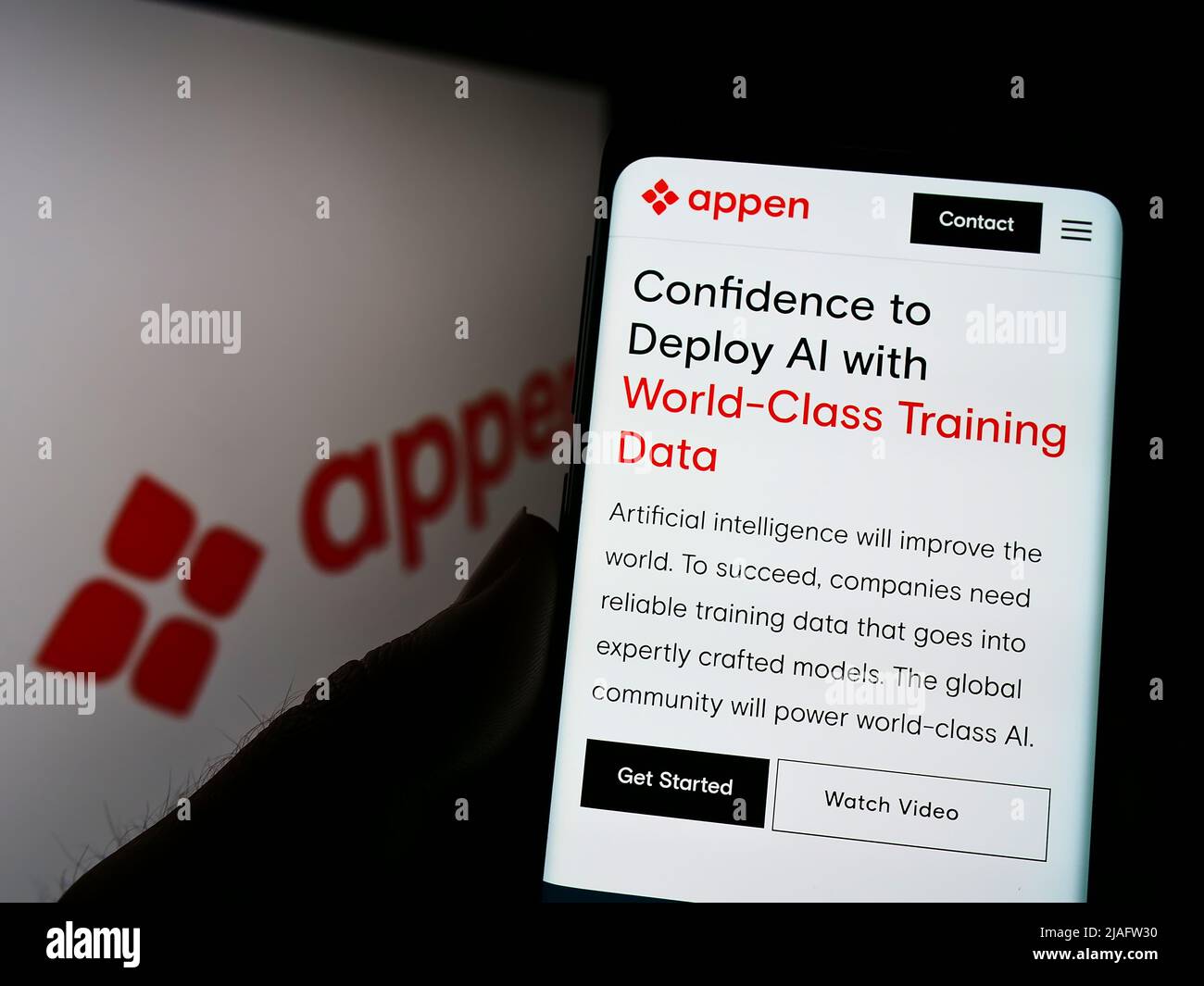 Person holding smartphone with webpage of Australian data company Appen ...