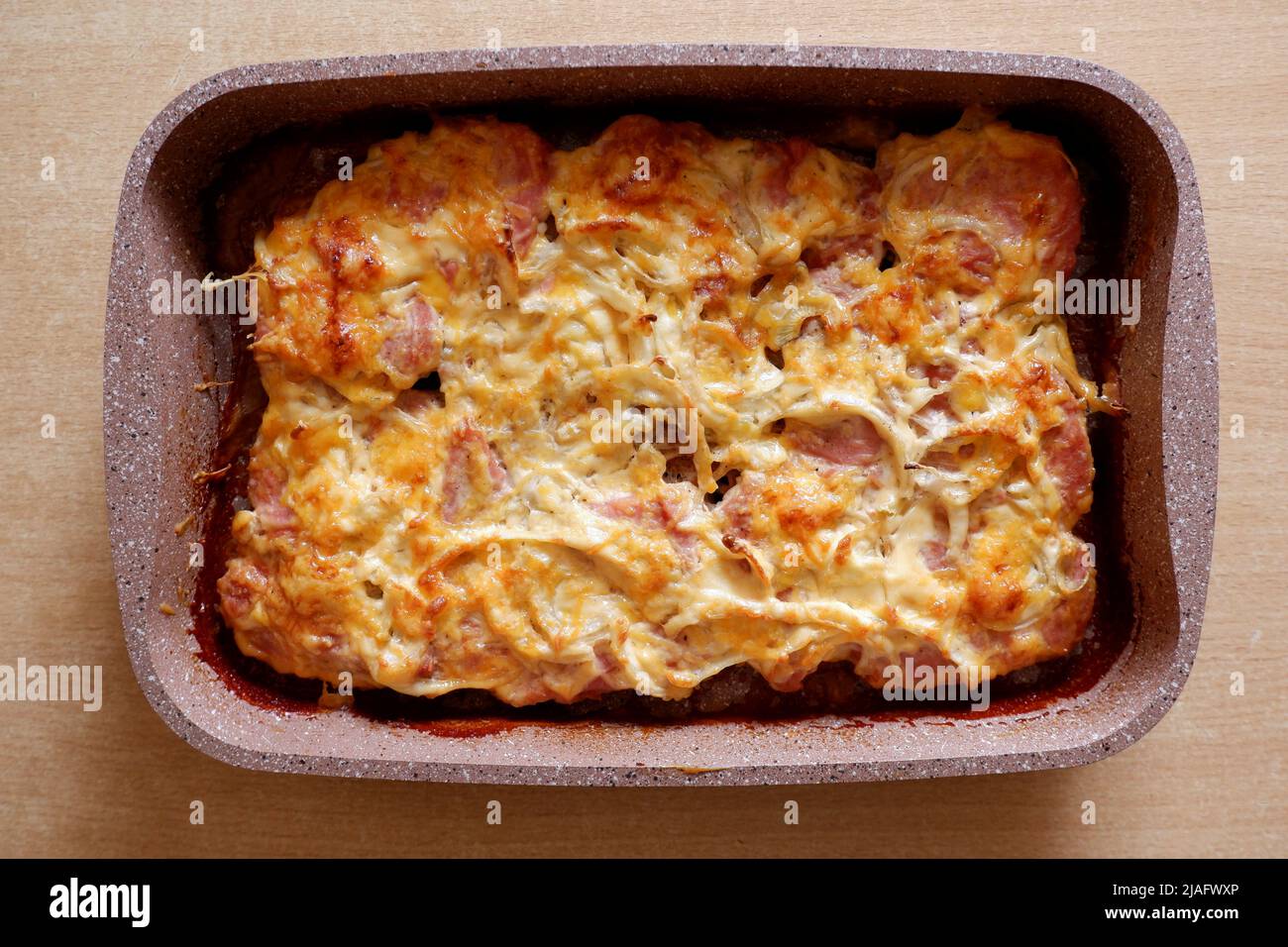 Baked meat with cheese in a ceramic mold Stock Photo - Alamy