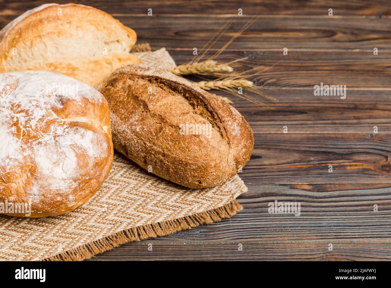 Homemade natural breads. Different kinds of fresh bread as background ...