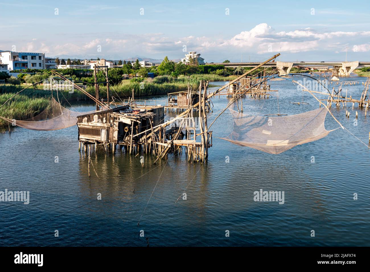 Floating house in the middle of a lake with protruding fishing nets ...