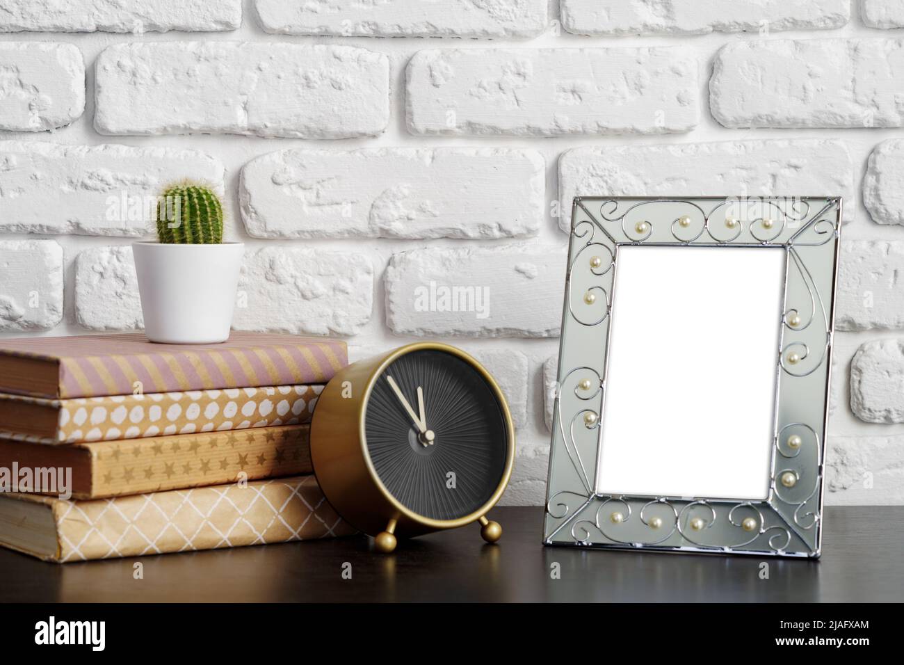 Books with picture frame on wooden table Stock Photo - Alamy