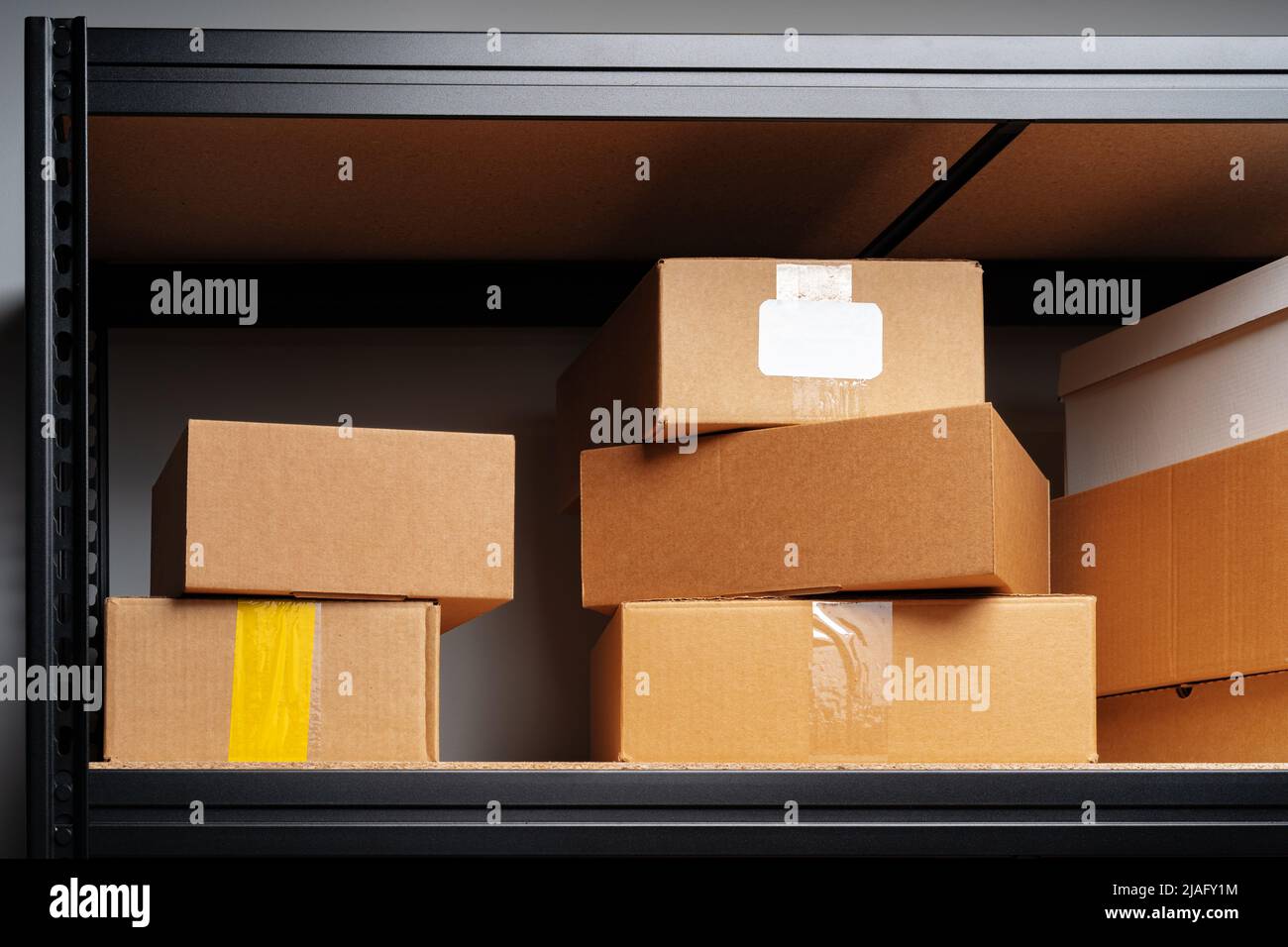 Rows of shelves with cardboard boxes in modern warehouse Stock Photo ...