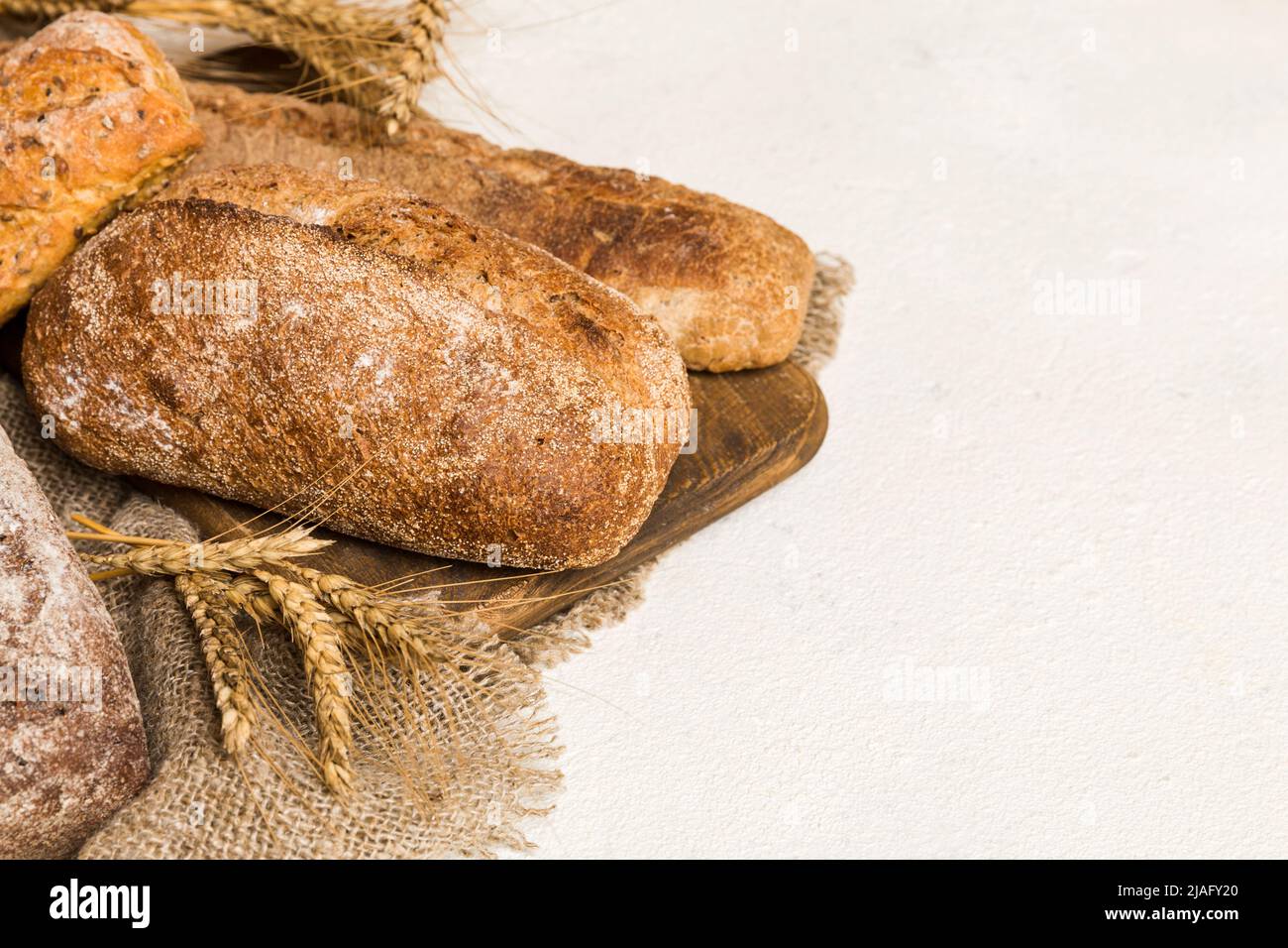 Homemade natural breads. Different kinds of fresh bread as background ...