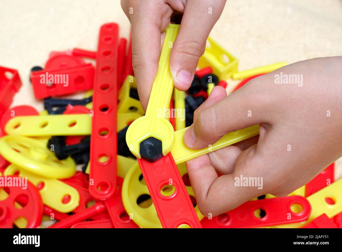 Child's hands with creative kit assembly tool Stock Photo - Alamy