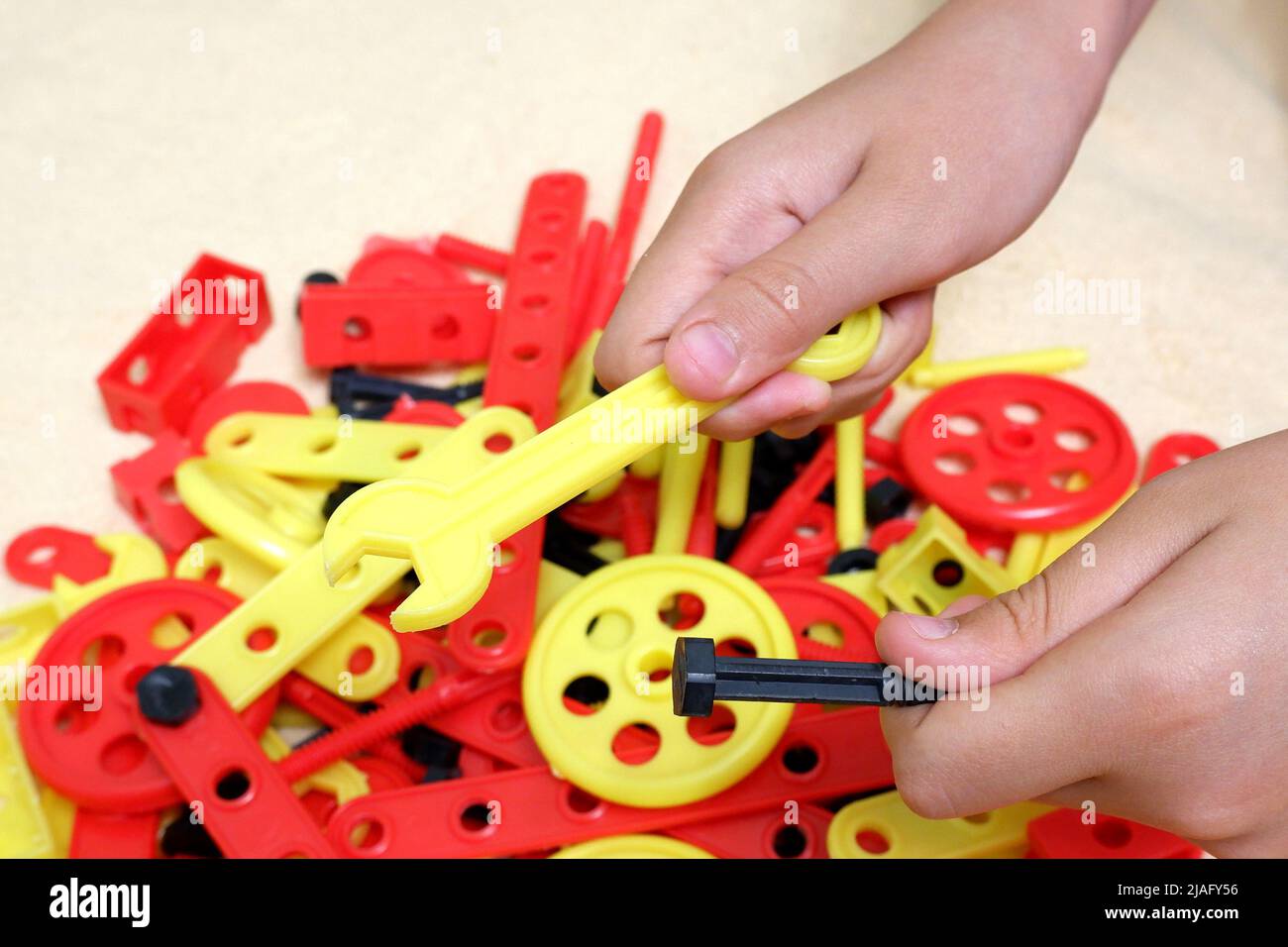 Child's hands with creative kit assembly tool Stock Photo - Alamy