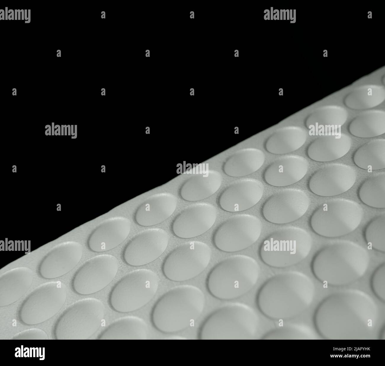 empty test tube rack on black background Stock Photo - Alamy