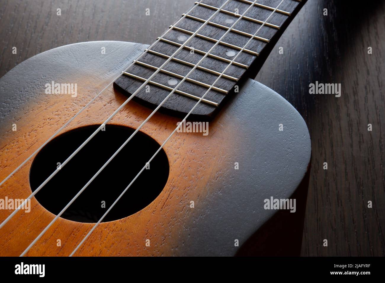 Ukulele soundboard, strings and fretboard close up Stock Photo - Alamy