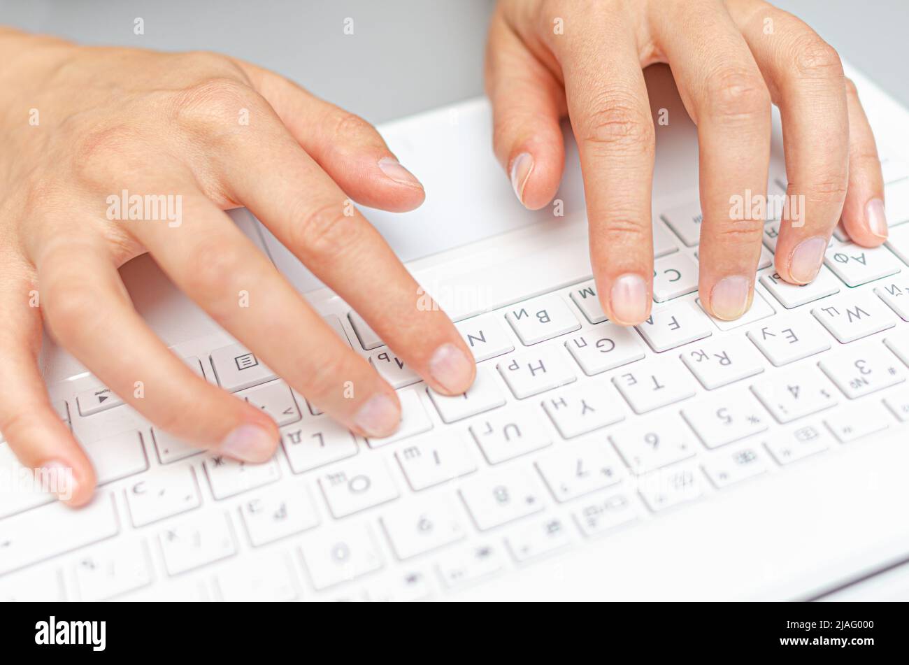 Human hands are typing on a white computer keyboard Stock Photo - Alamy
