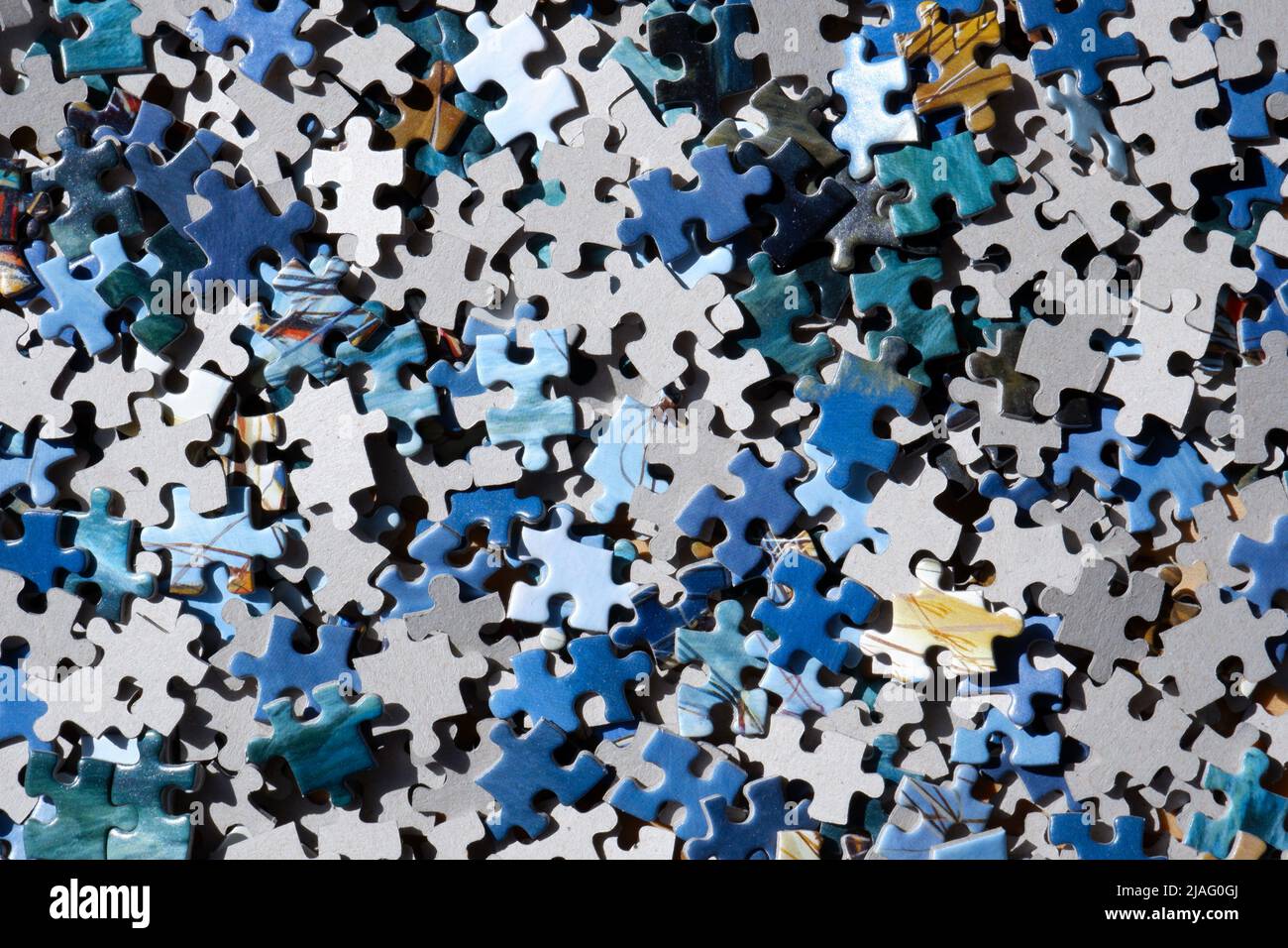 Abstract background of scattered puzzle pieces Stock Photo - Alamy