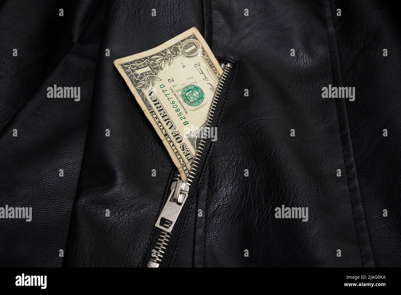 Dollar bill in leather jacket pocket Stock Photo - Alamy