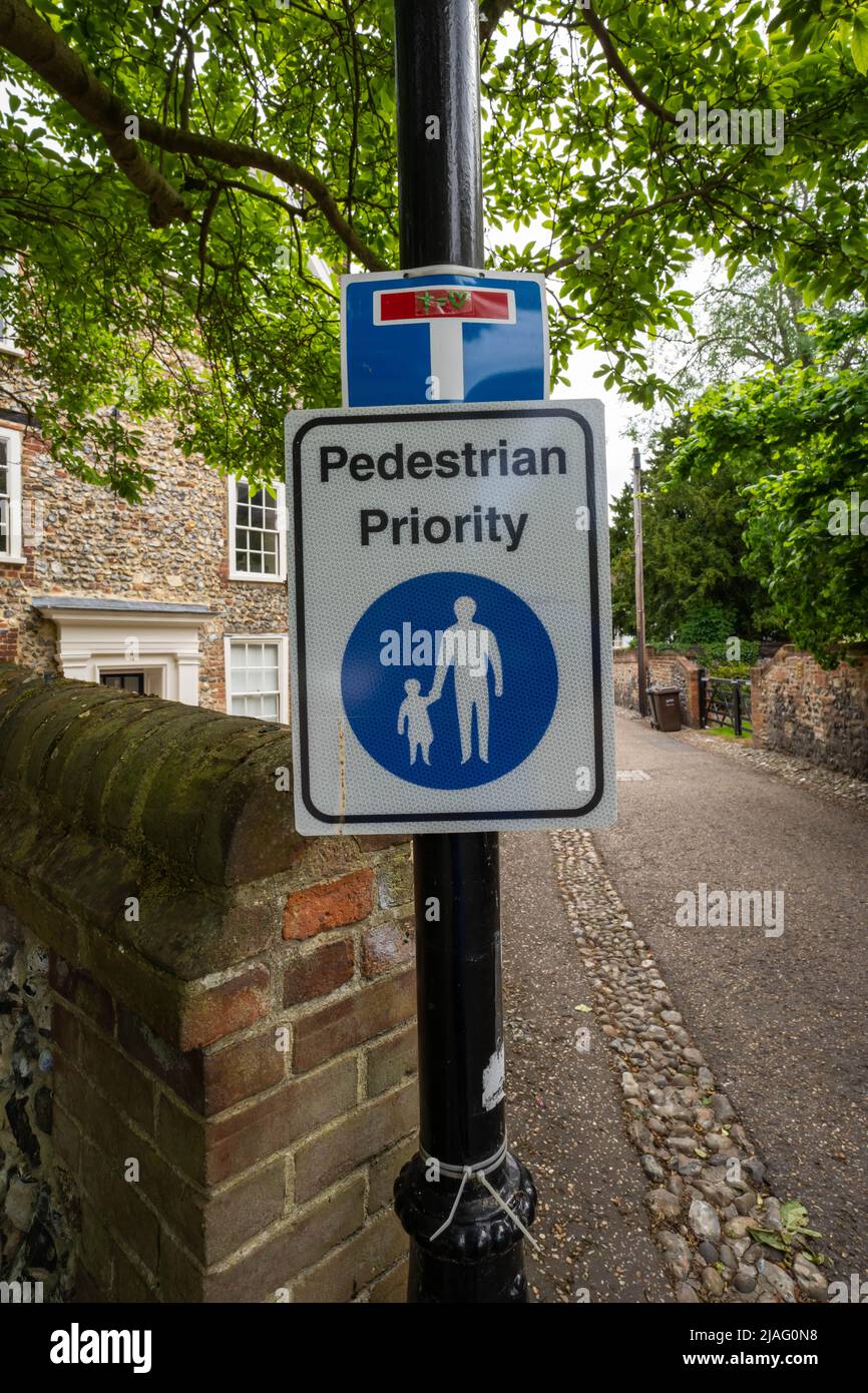 pedestrian priority sign on a street light in the grounds of Norwich ...