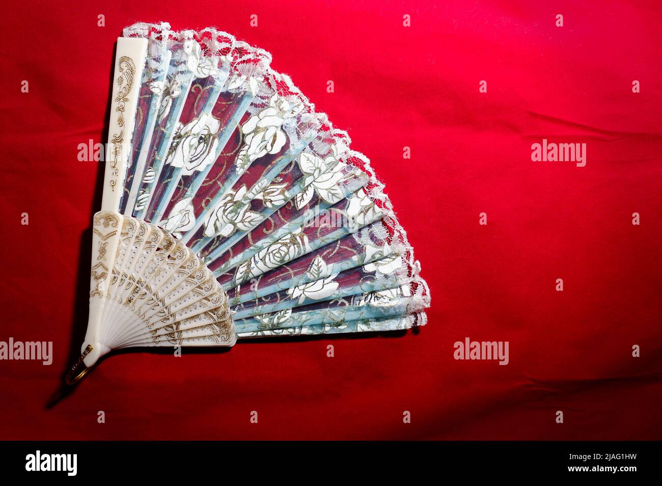 Opened Japanese fan on a red background Stock Photo - Alamy
