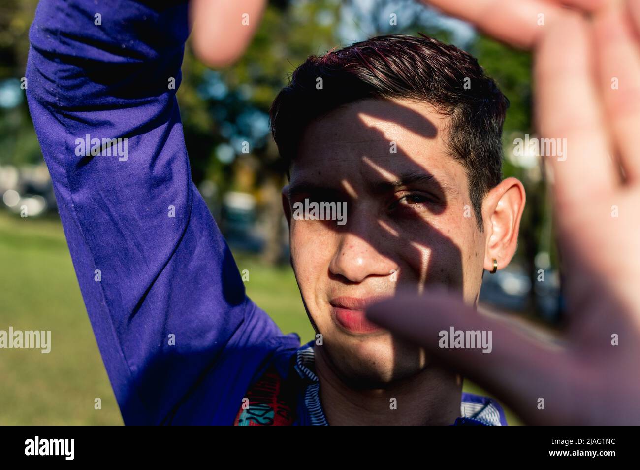 Man covering eyes in park hi-res stock photography and images - Alamy