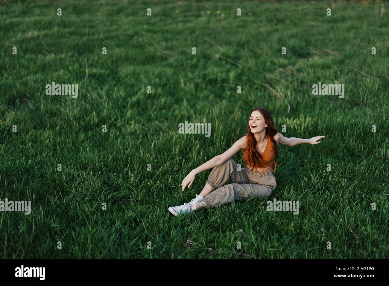 Young Woman Playing Games In The Park On The Green Grass Spreading Her 8663