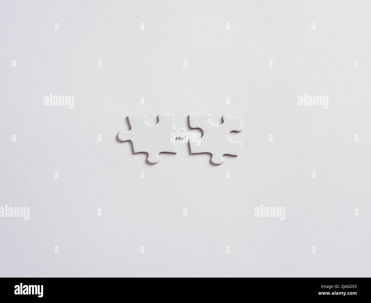 Two blank or empty jigsaw puzzle pieces is about to connect on white ...