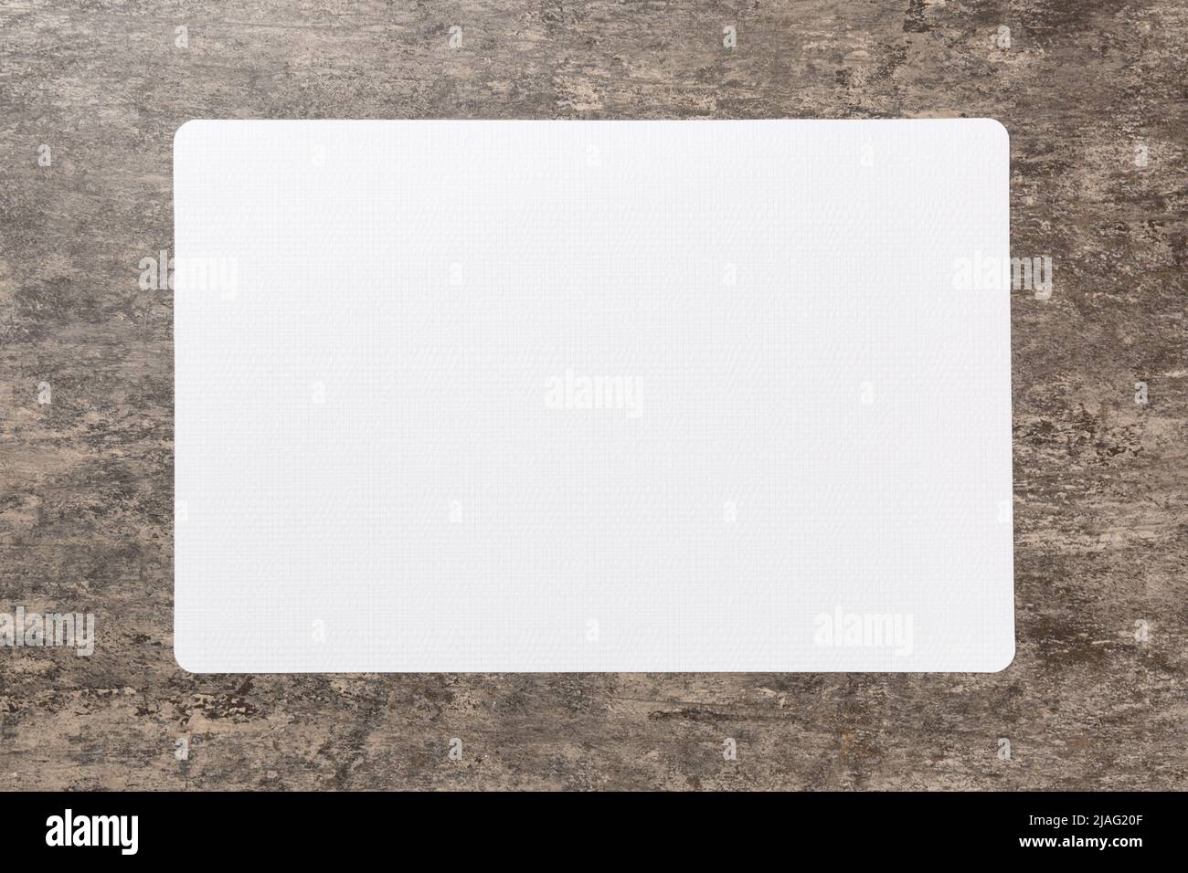 Top view of light tablecloth for food on cement background. Empty space ...