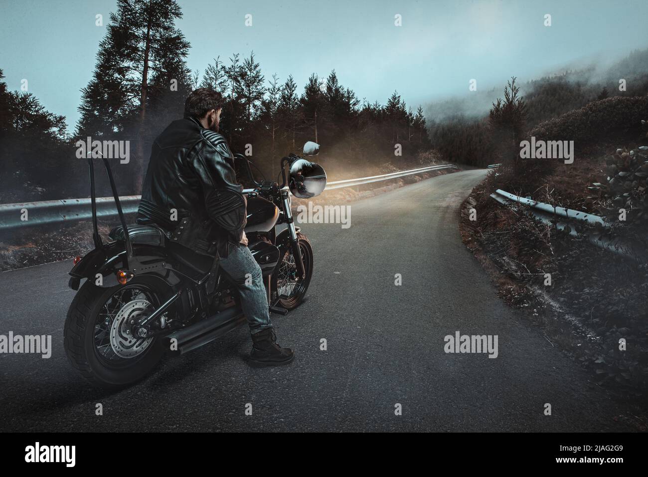 Rear view of muscular man, professional biker in leather outfit sitting ...