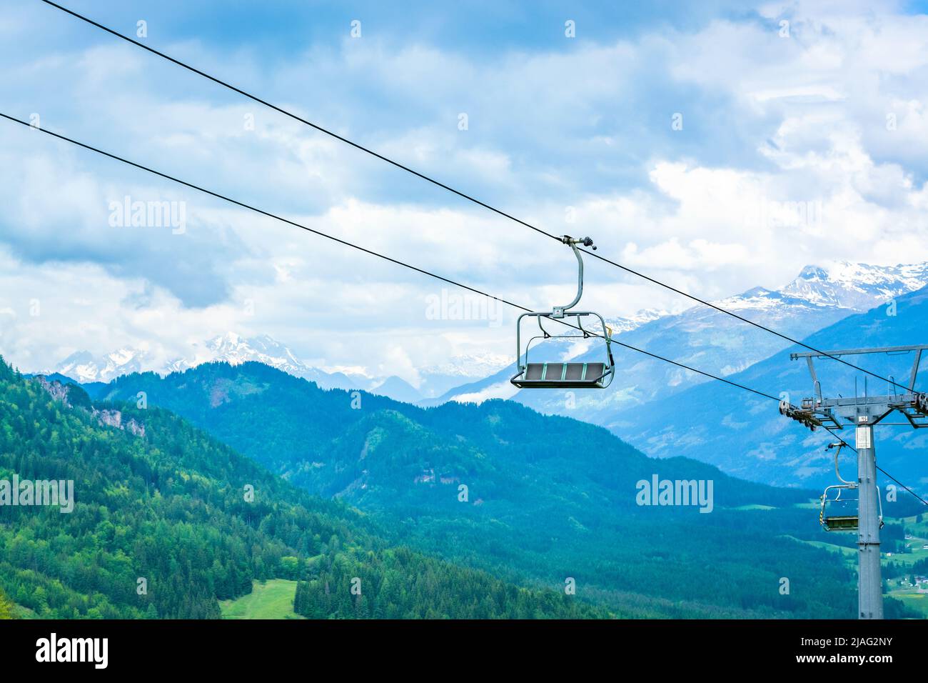 View from the high seat of the cable car against the backdrop of green ...