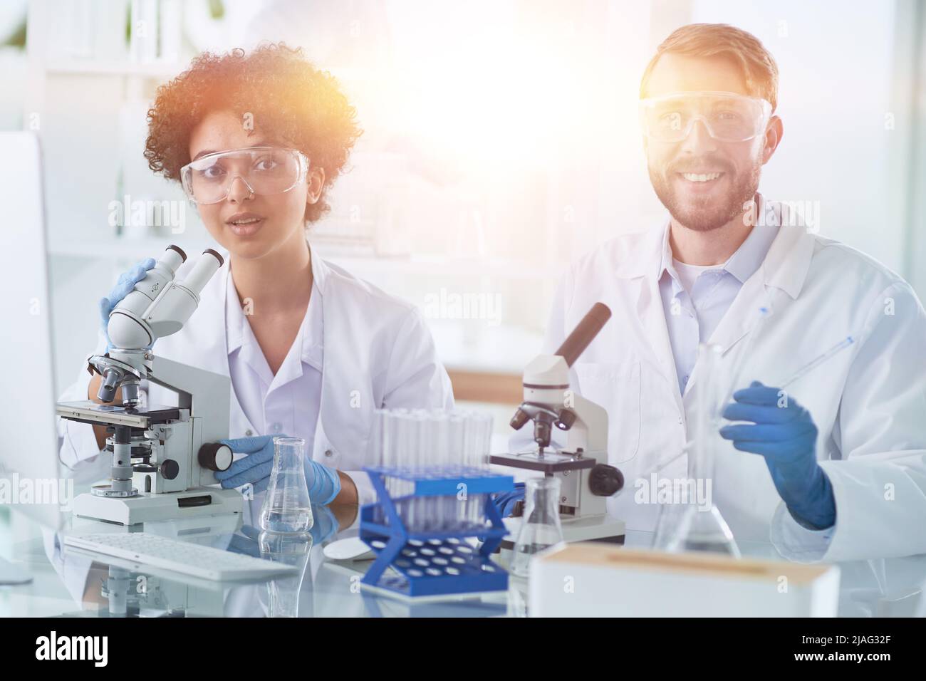 Smiling scientists looking at camera arms crossed in laboratory Stock ...