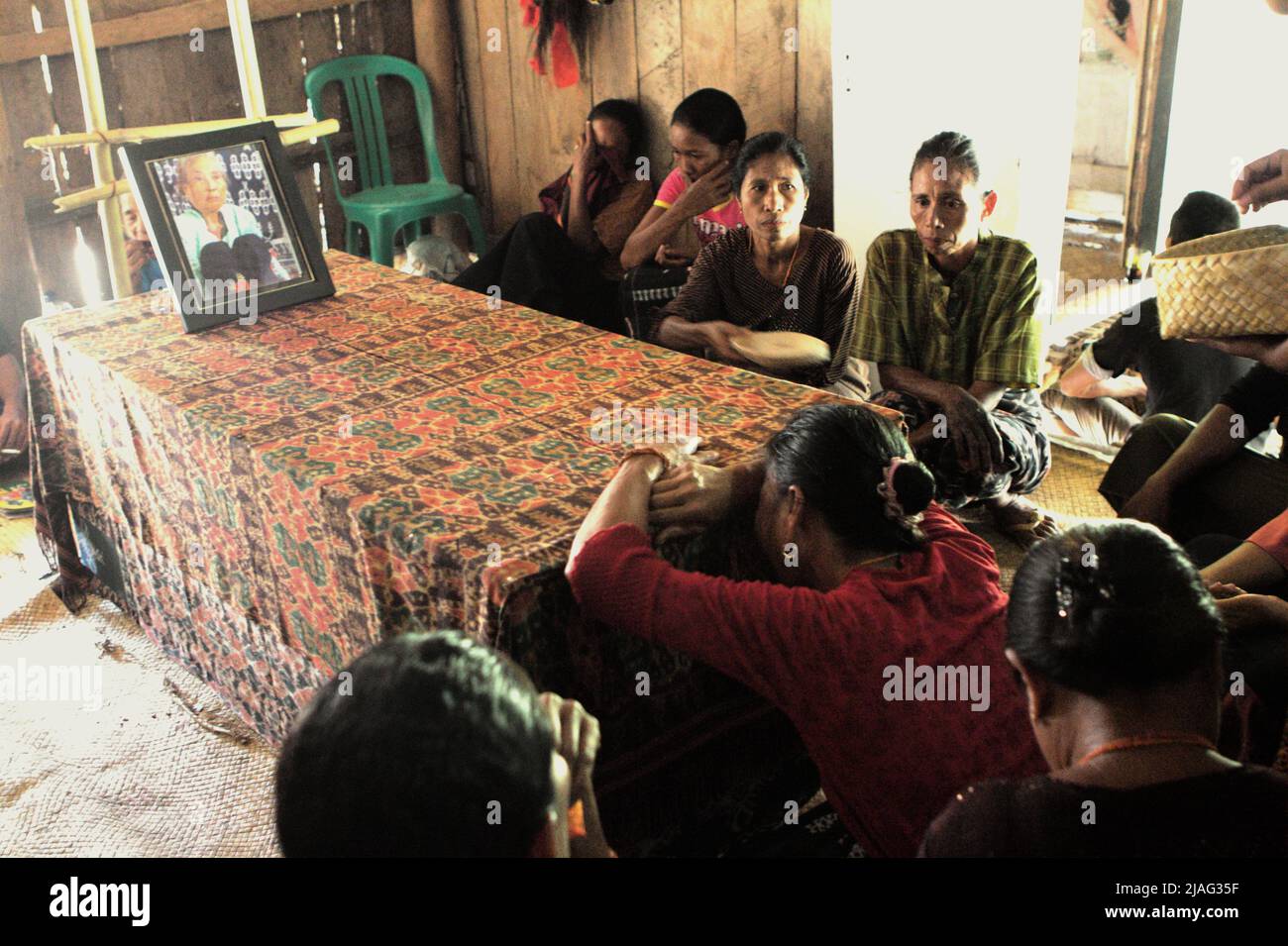 A woman mourns during a mourning session as one of her family members ...