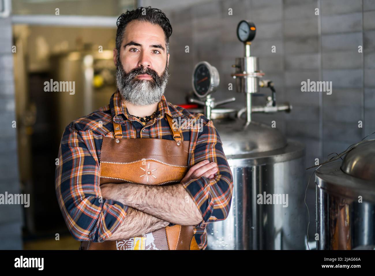 Portrait of man who is working at craft beer factory. Small family ...