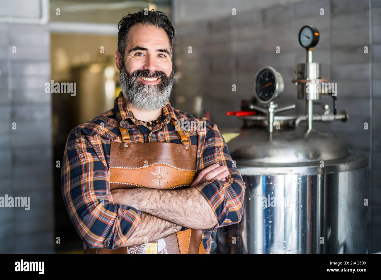 Portrait of man who is working at craft beer factory. Small family ...