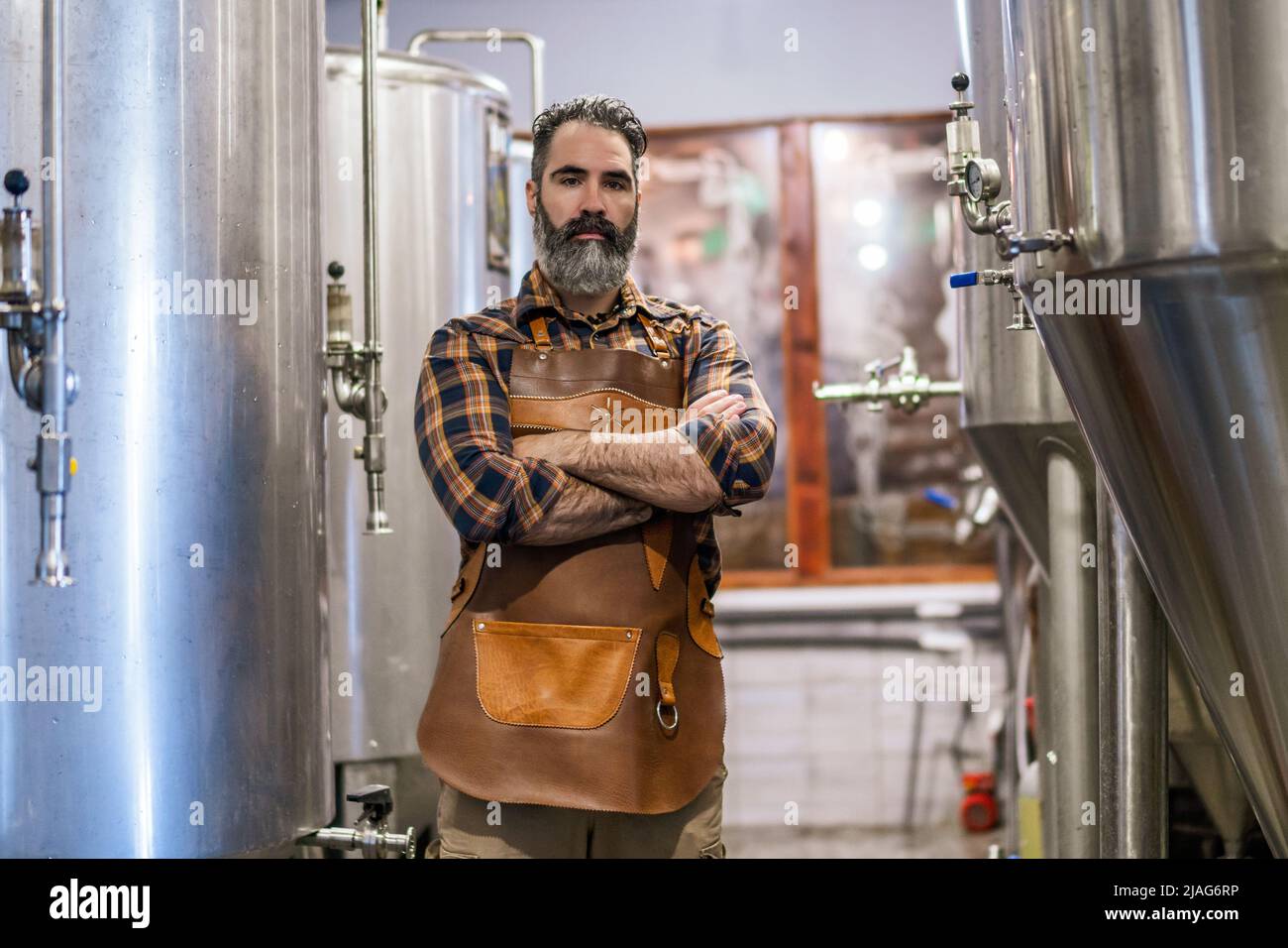 Portrait of man who is working at craft beer factory. Small family ...
