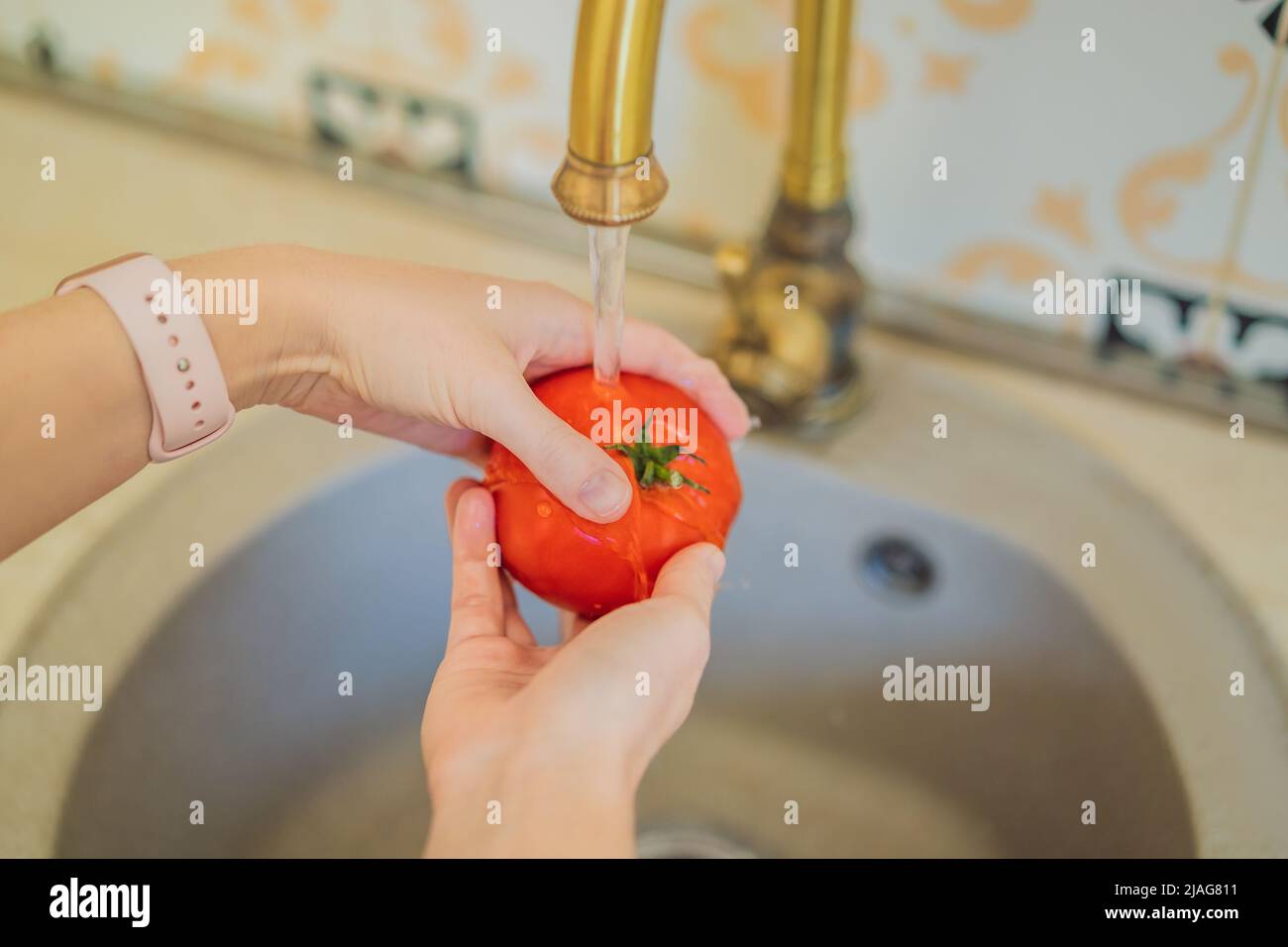 Close-up Of A Woman Washing Tomato In Running Water Under Tap Stock ...