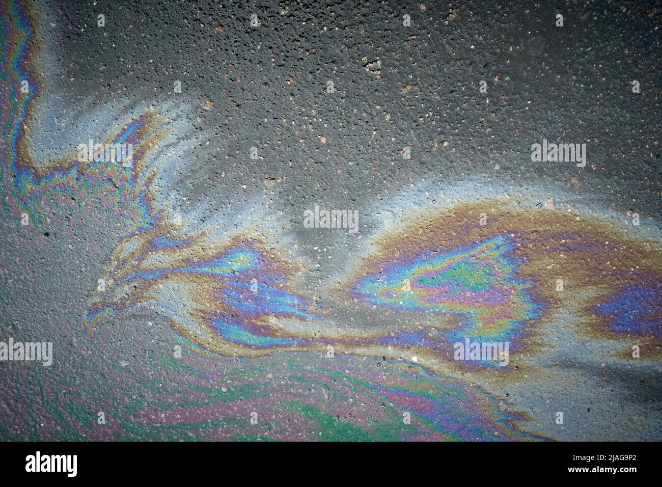 Gasoline spill on the pavement as a texture or background resembling a ...