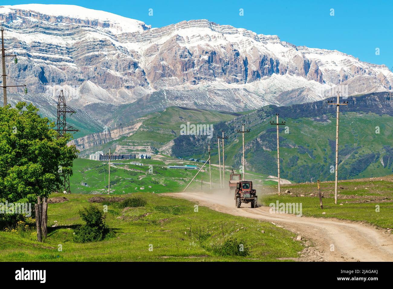 Tractor driving on a country road Stock Photo - Alamy