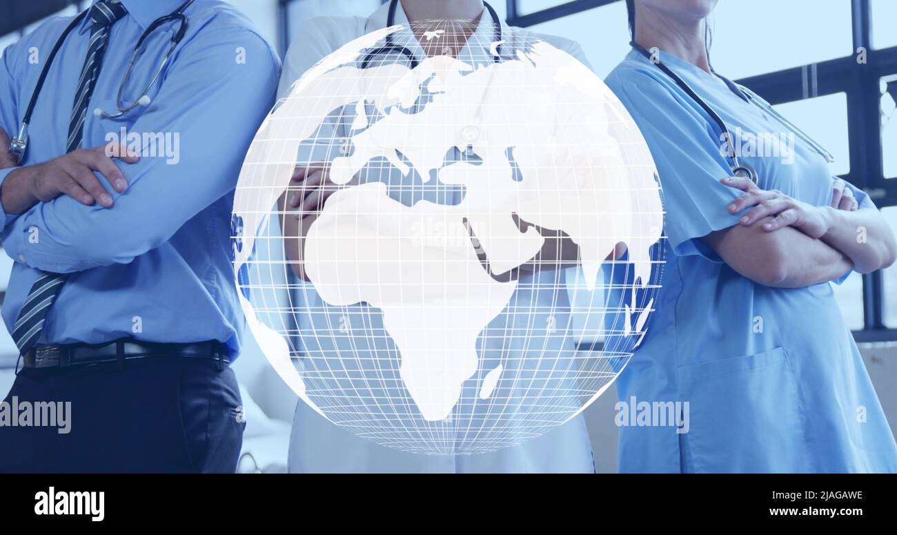 Image of spinning globe model over diverse medical staff. world health ...