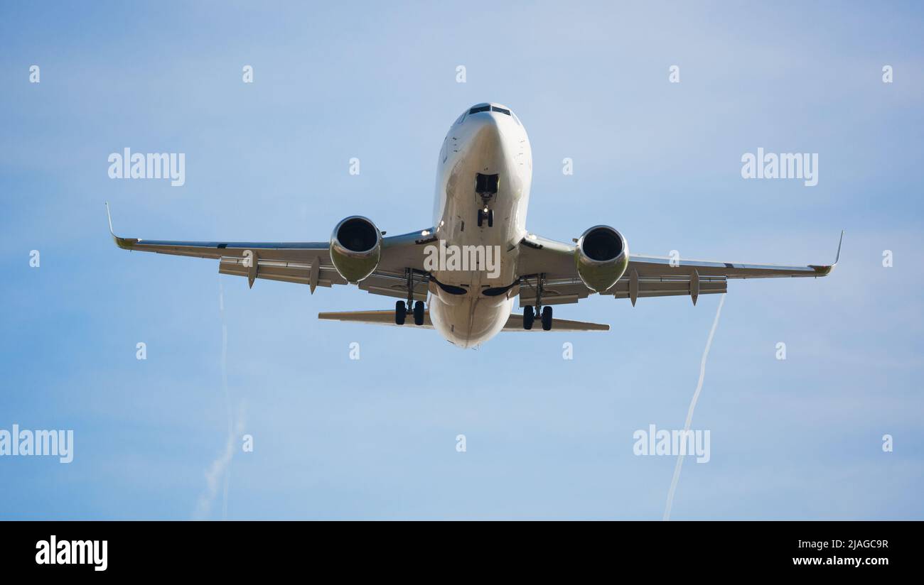 Passenger plane departing in afternoon Stock Photo - Alamy
