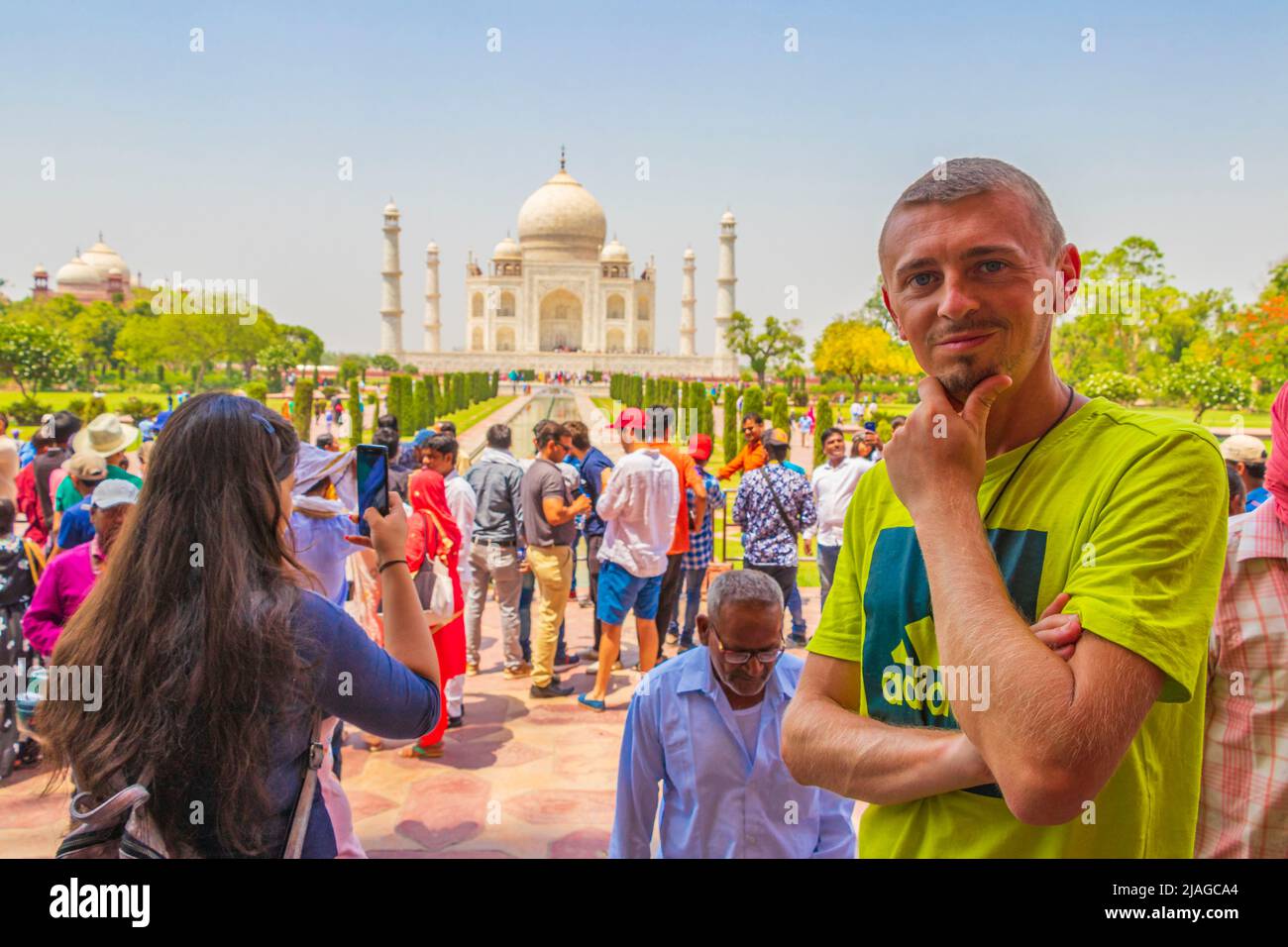 Traveler and tourist poses in front of the famous Taj Mahal in Agra ...