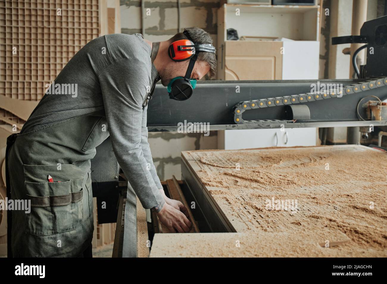 Side view portrait of male worker wearing full protective gear while ...