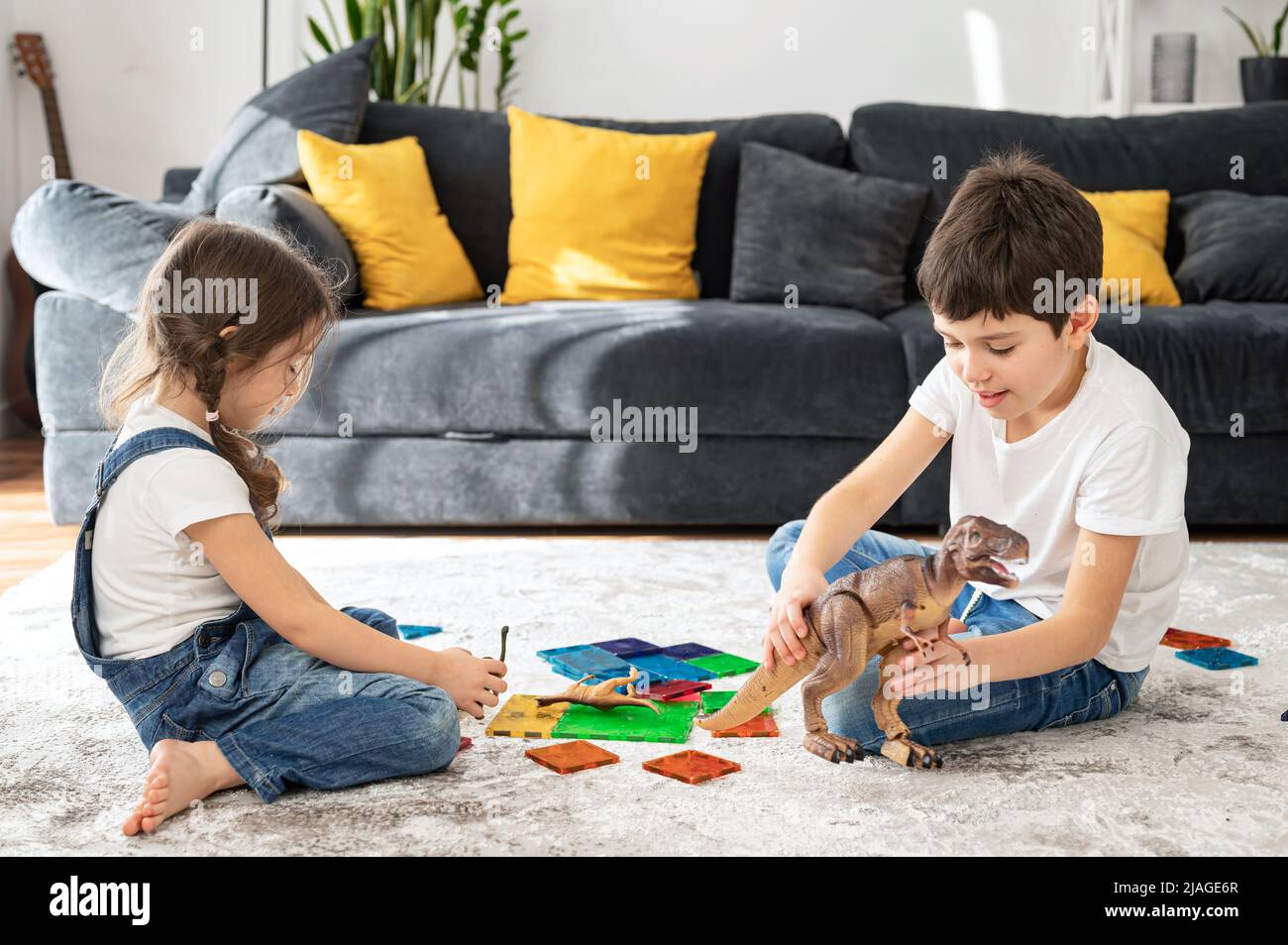 Children brother and sister playing with constructor on the floor in ...