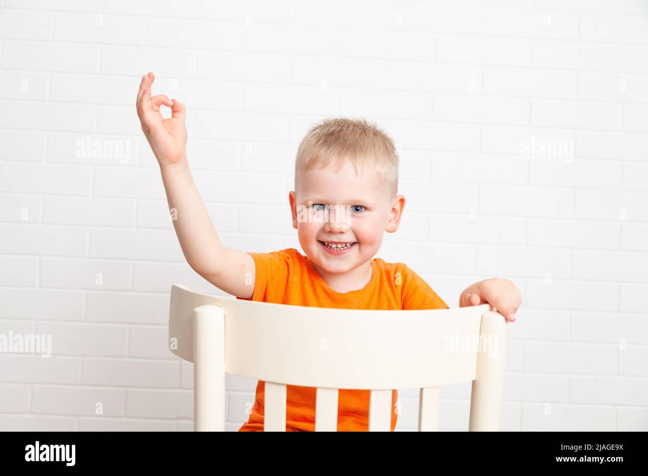 Little European boy shows ok Stock Photo - Alamy
