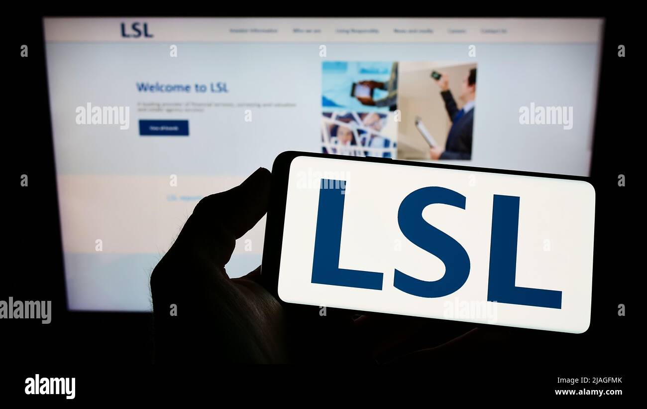 Person holding smartphone with logo of British company LSL Property ...