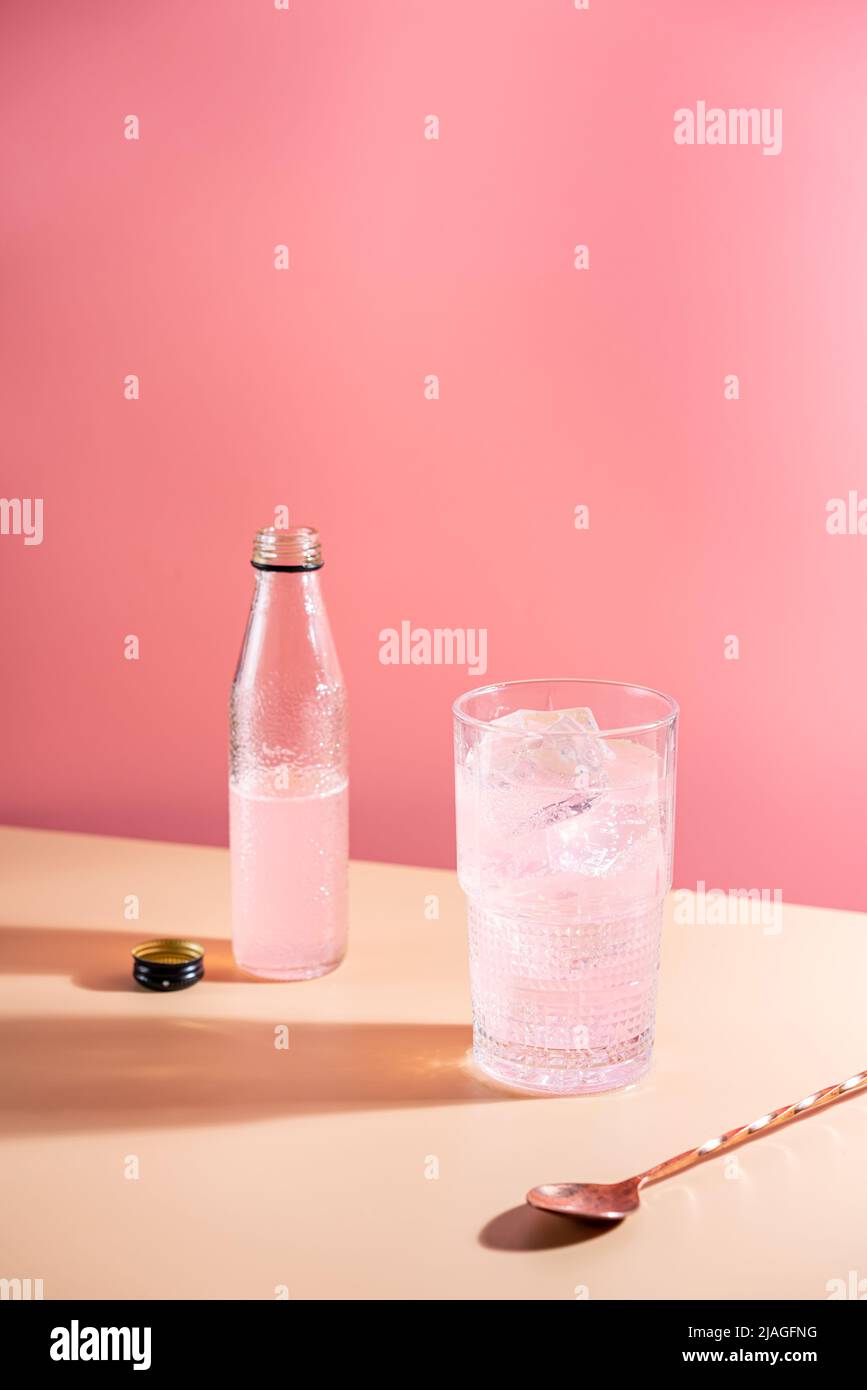 Summer refreshment pink drink with ice. Light pink rose cocktail on a ...