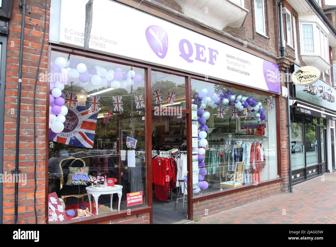 QEF charity shop with Queen's 70th Jubilee decorated shop window, Craddock's Parade, Ashtead ...