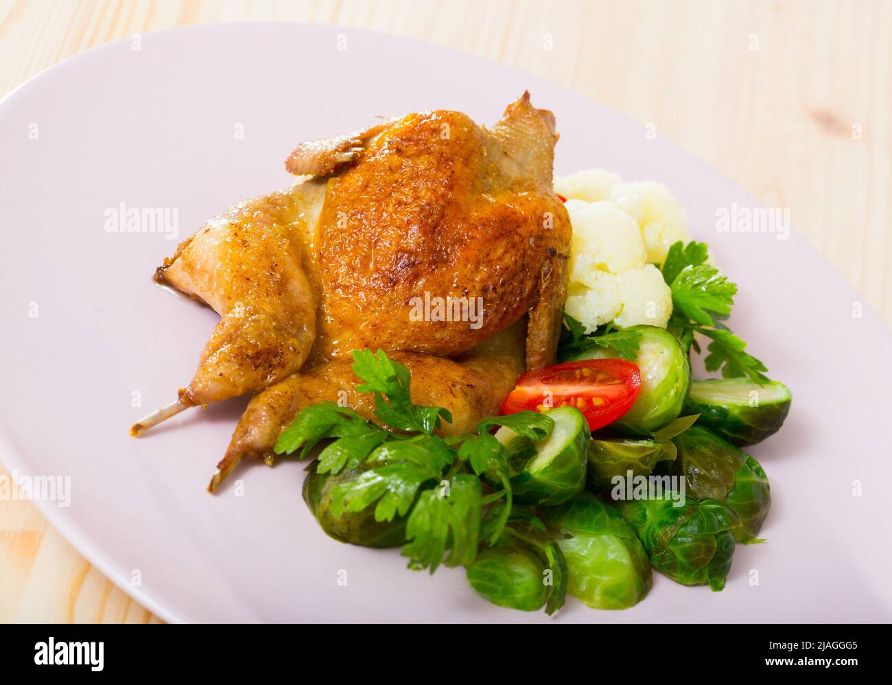 Grilled partridge with steamed vegetables Stock Photo - Alamy