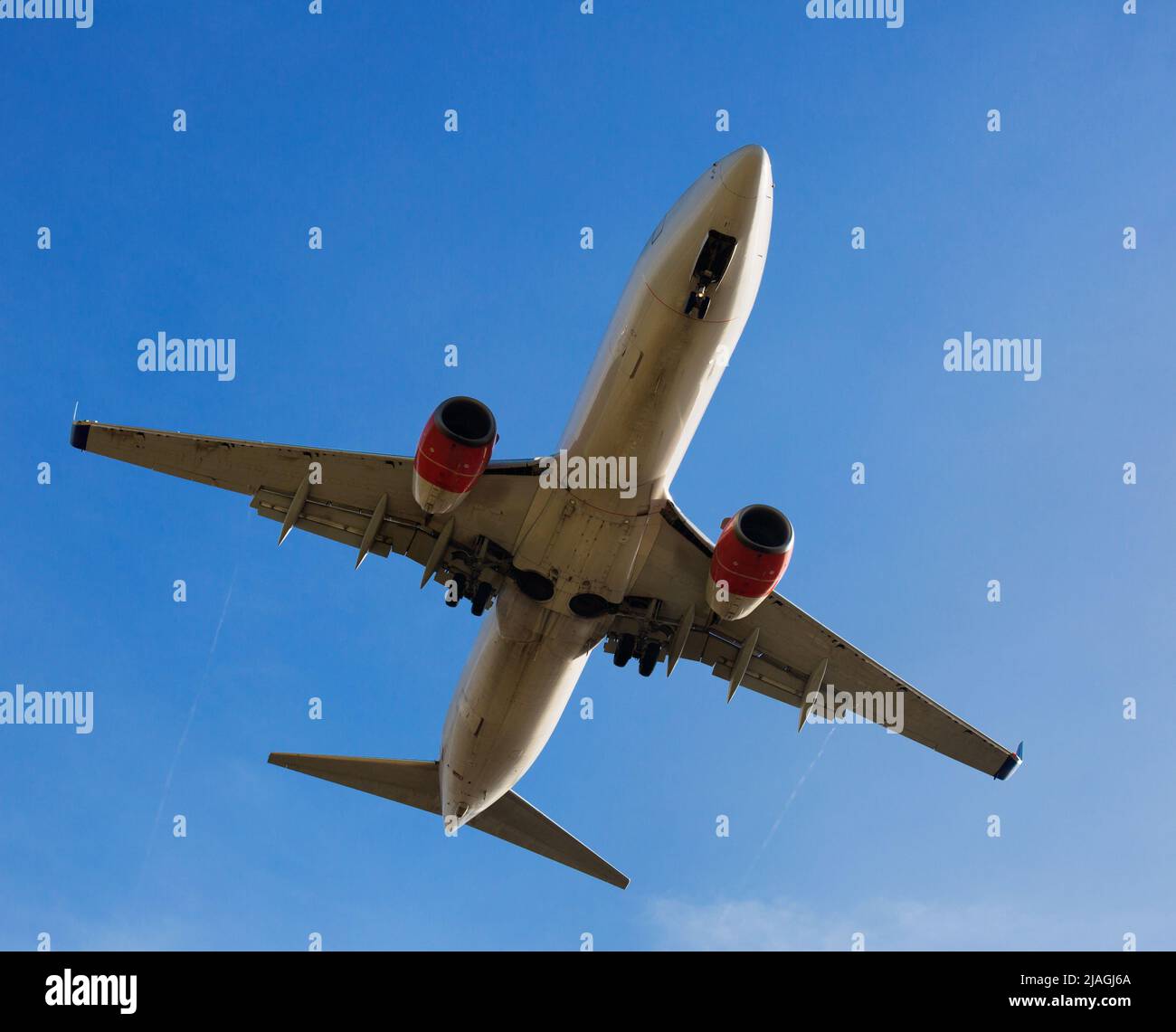 Passenger plane departing in afternoon Stock Photo - Alamy
