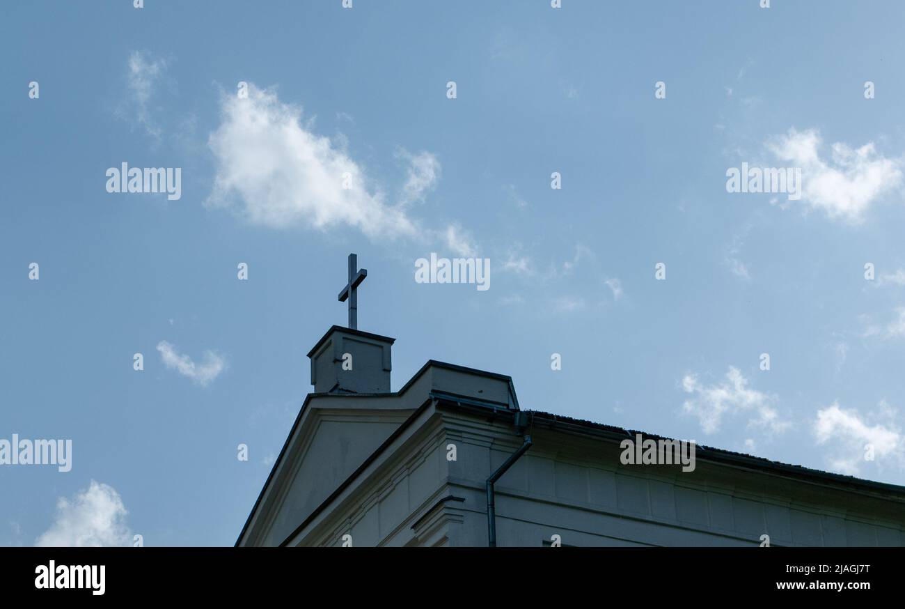 Cross on roof of Catholic cathedral on background of blue sky with ...