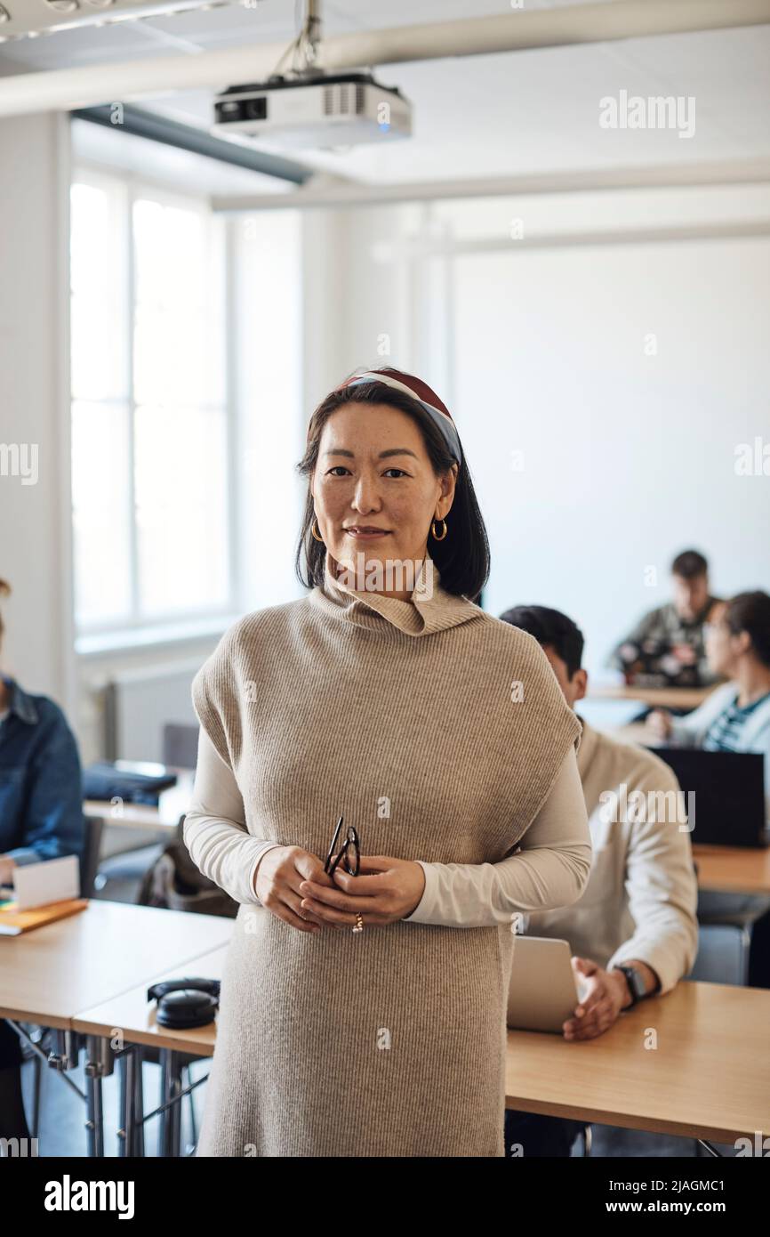 Portrait of female professor standing in classroom Stock Photo - Alamy